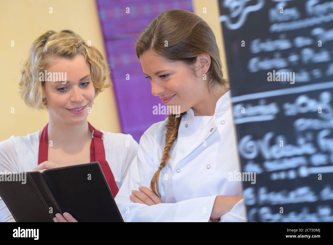 chef writing something in clipboard in modern kitchen Stock Photo - Alamy