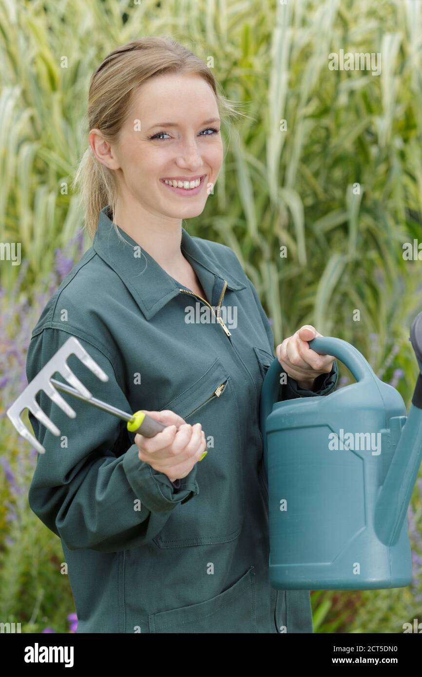 Woman using garden rake hi-res stock photography and images - Alamy