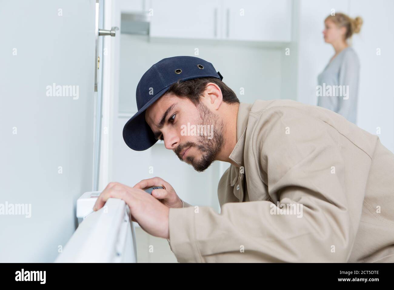 man fixing a heating radiator Stock Photo - Alamy
