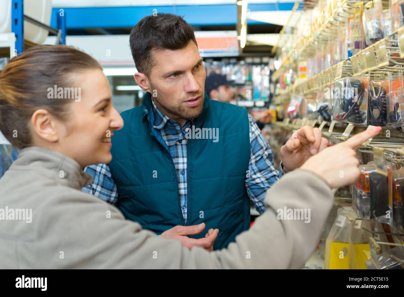 product distribution worker pointing at product on shelf Stock Photo ...