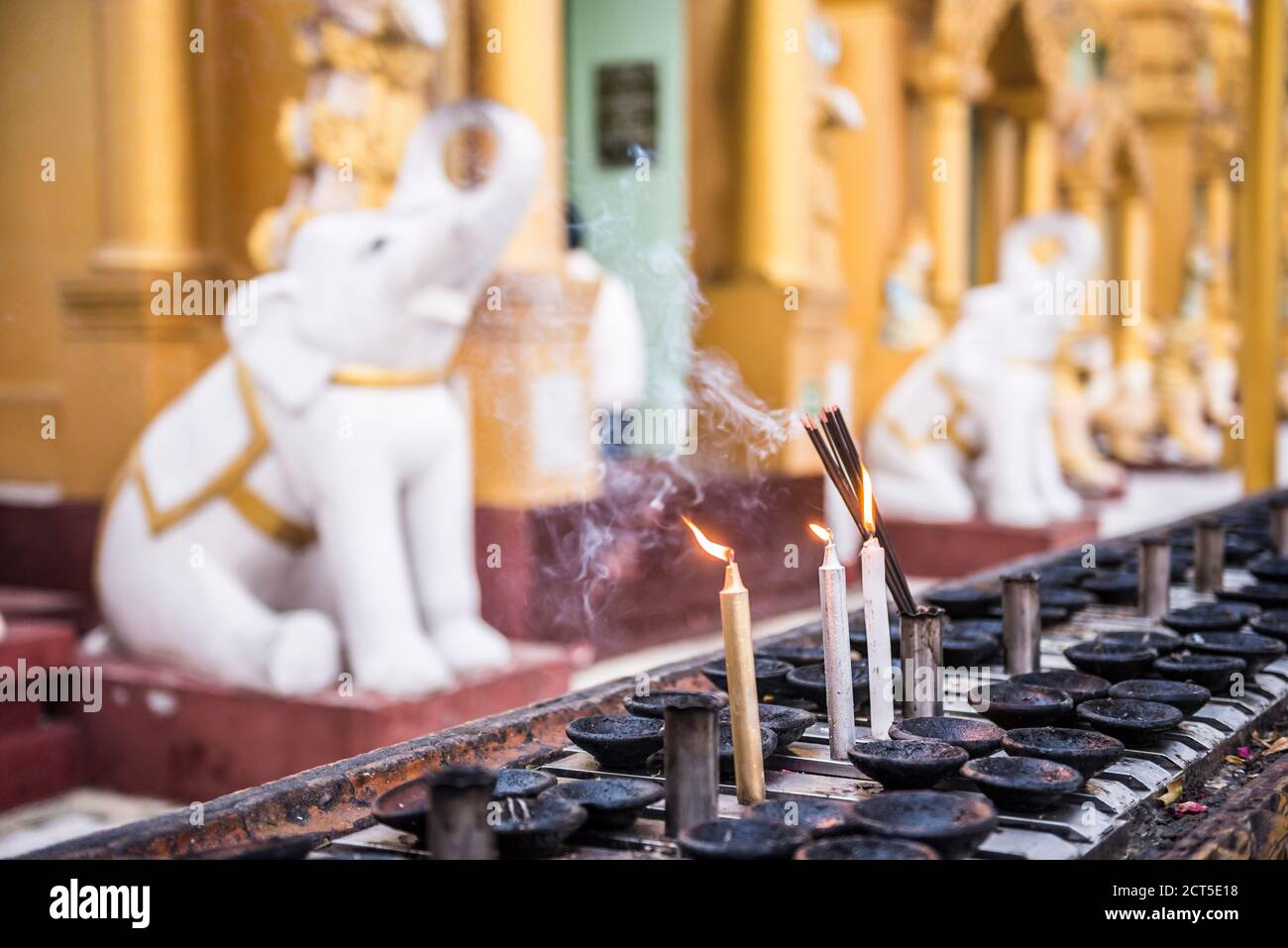Burning prayer candles at Shwedagon Pagoda (aka Shwedagon Zedi Daw or ...