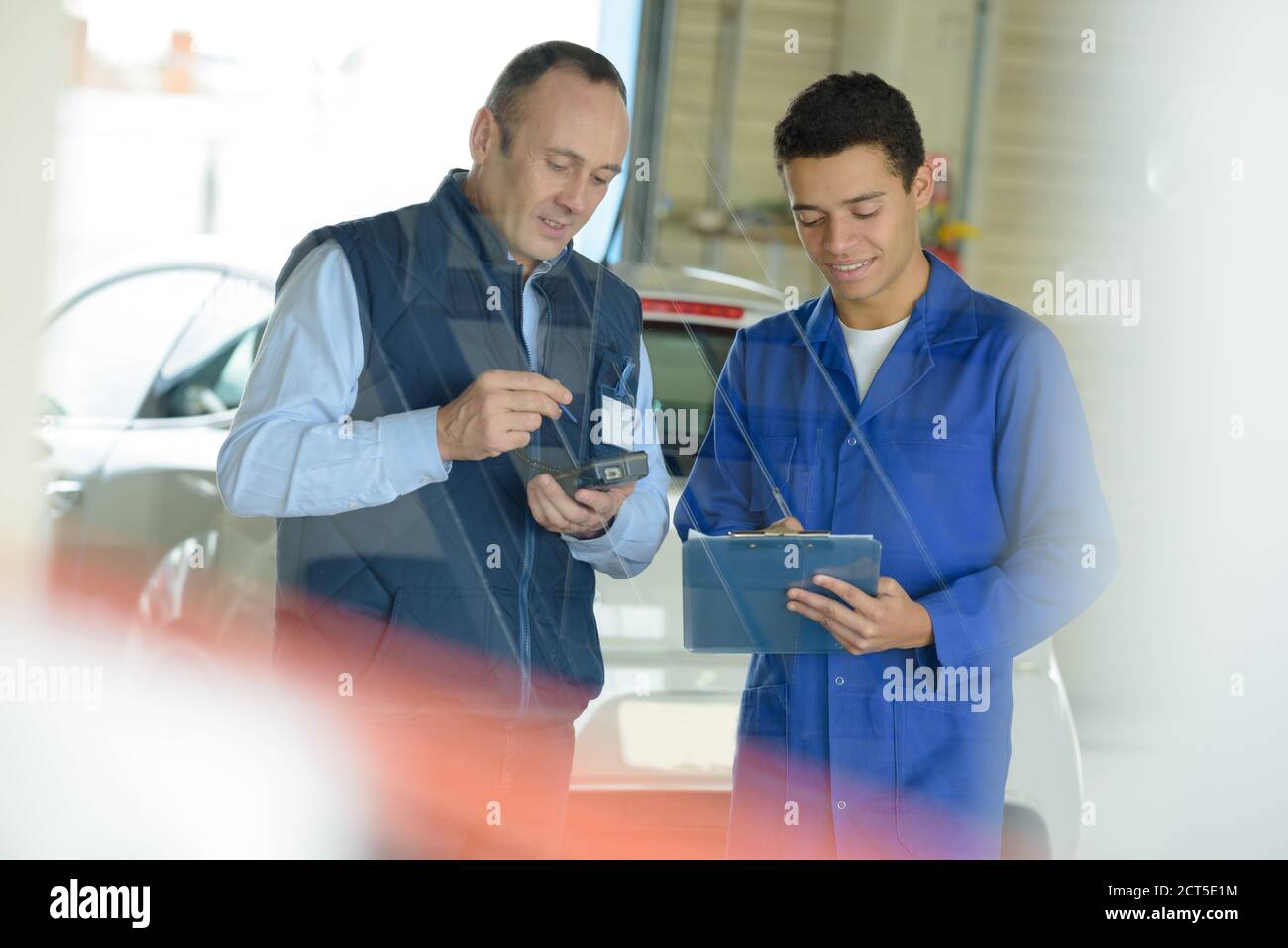 2 mechanic men try to fix and setup boat engine Stock Photo - Alamy