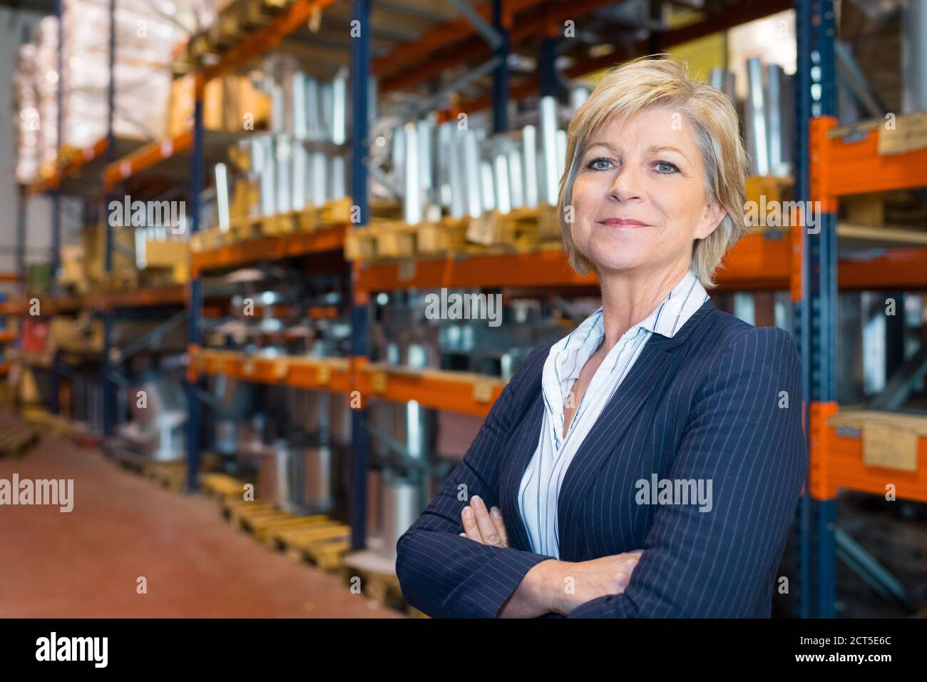 portrait of proud businesswoman in warehouse Stock Photo - Alamy