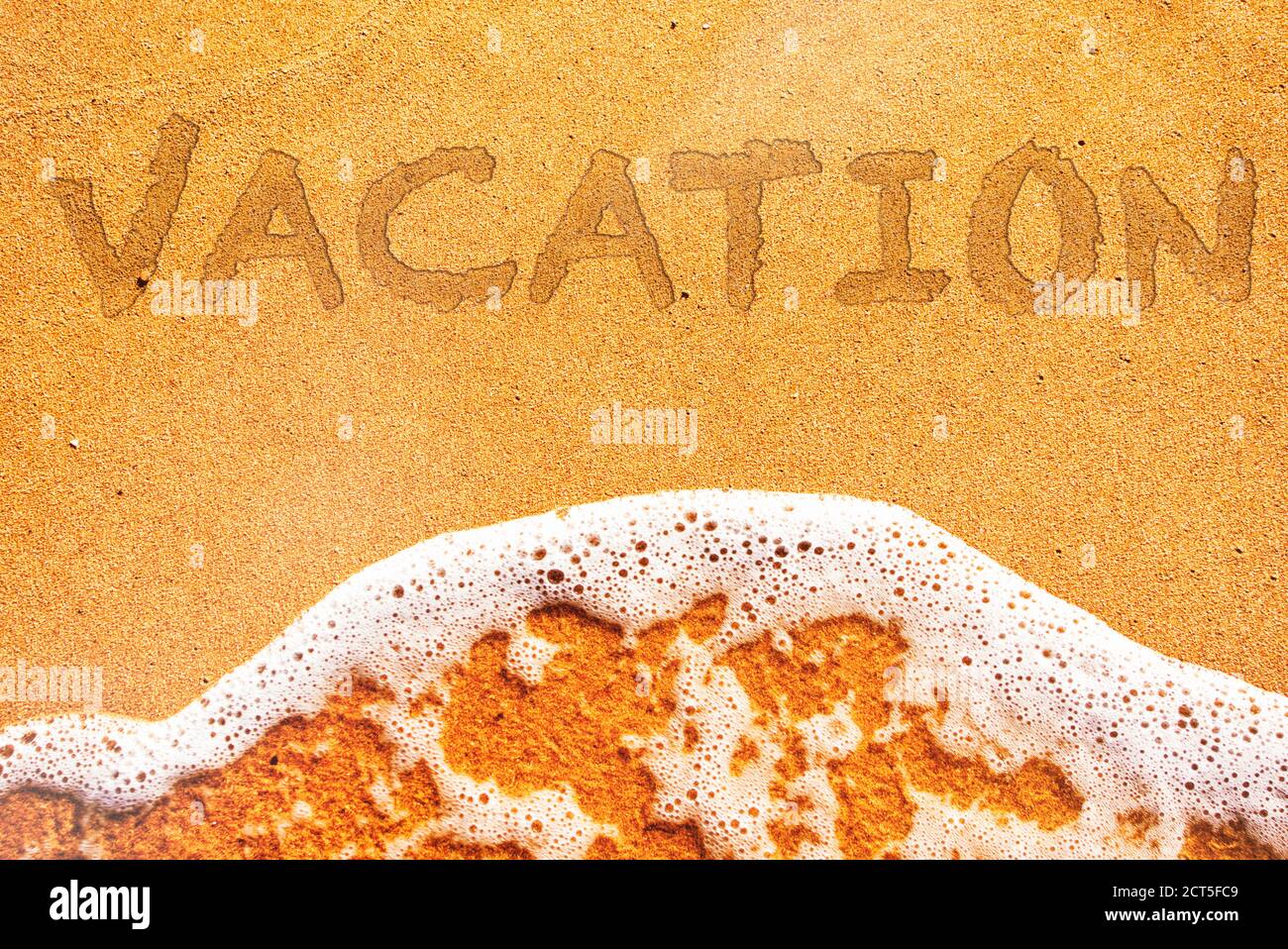 Foamy wave on sandy beach with word Vacation Stock Photo - Alamy