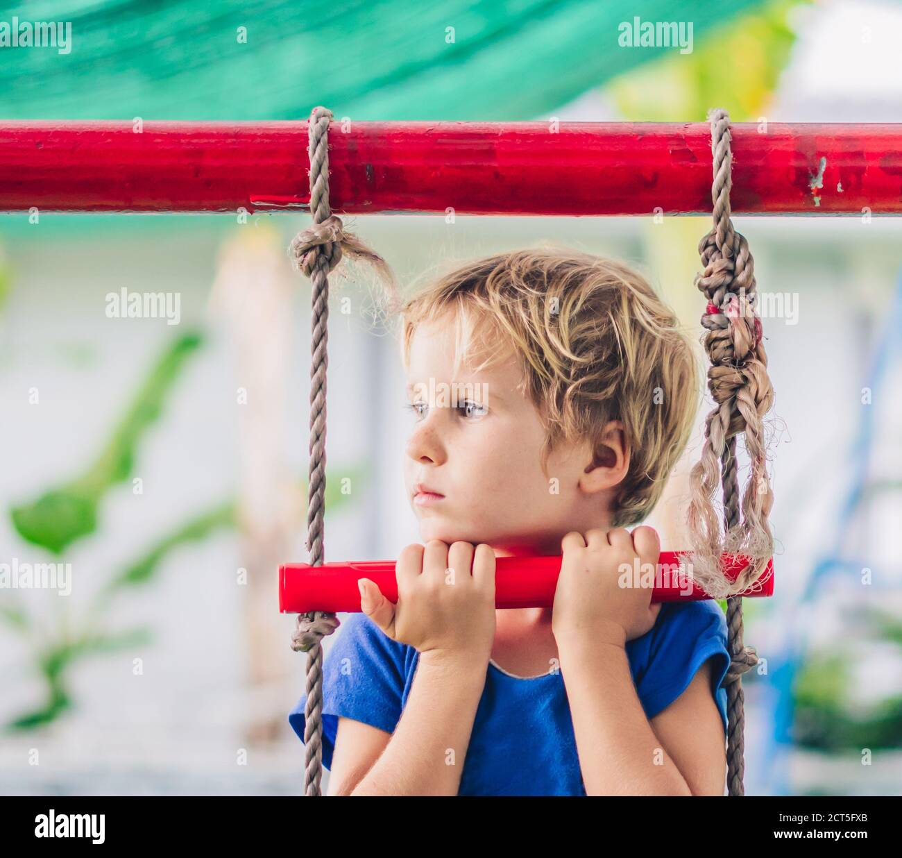 Close portrait Sad lonely freckled blue eyed cute blond little boy in t ...