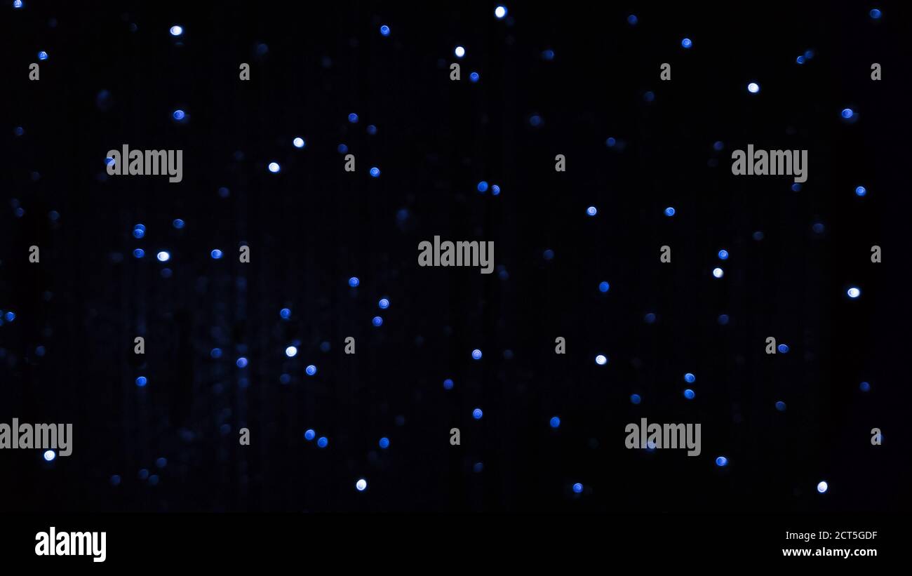 Blue blurred background of LED flashing, blinking and flickering bulbs ...