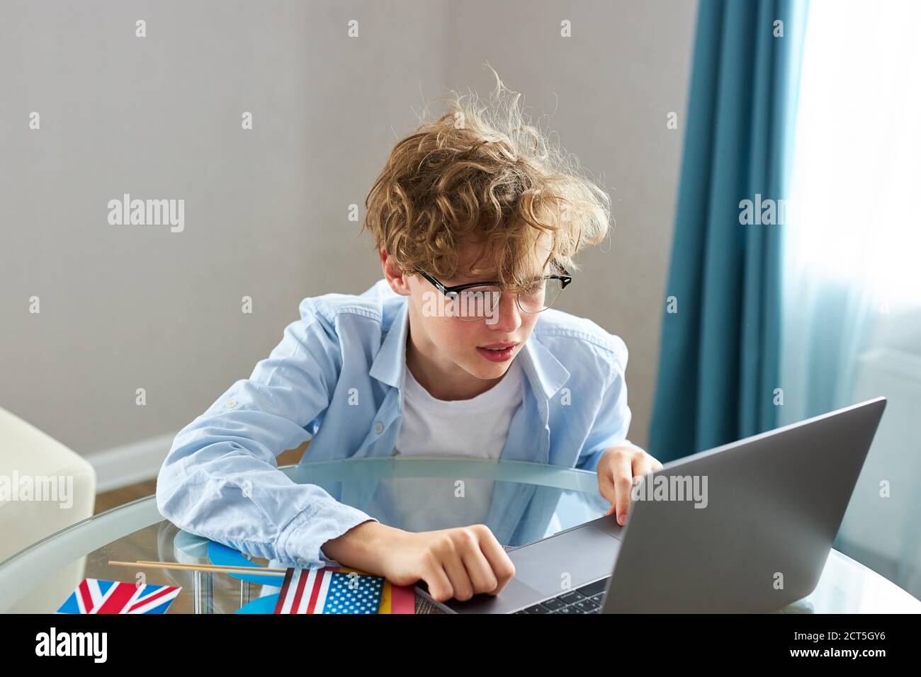 schoolboy is typing report on laptop, do homework. caucasian teen boy ...