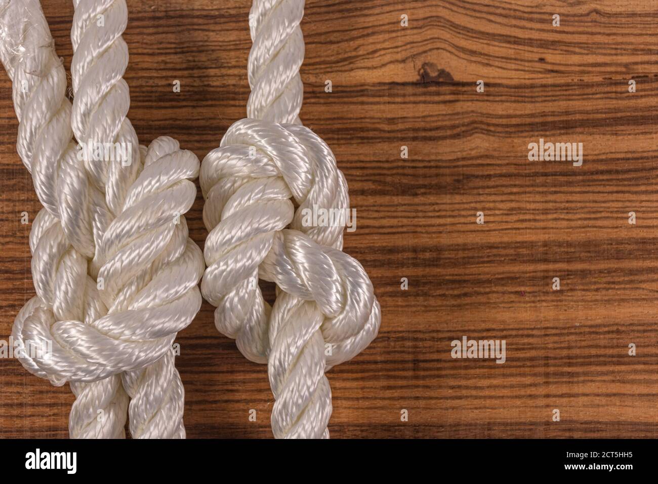 Knots with rope on wooden background with space for writing. Concept of ...