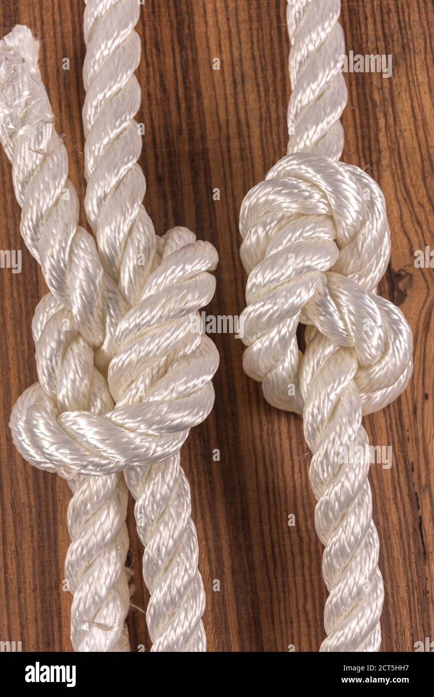 Knots with rope on wooden background with space for writing. Concept of ...
