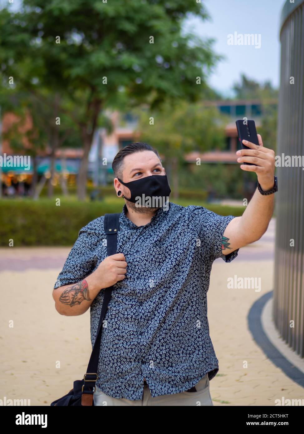 Shot of a man taking a selfie in a medical mask - new normal Stock ...