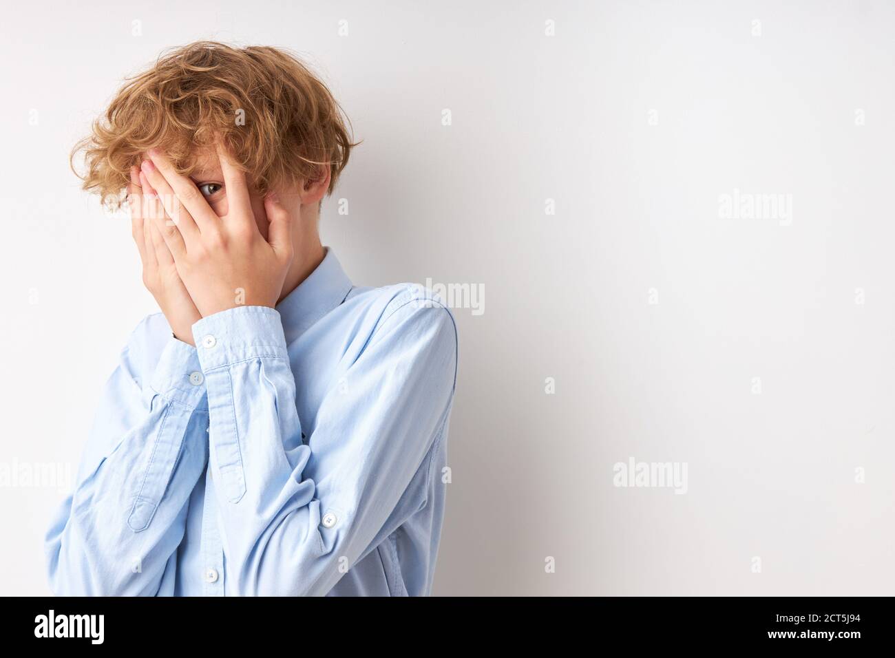 scared curly boy afraid of something, expressive emotional boy cannot ...