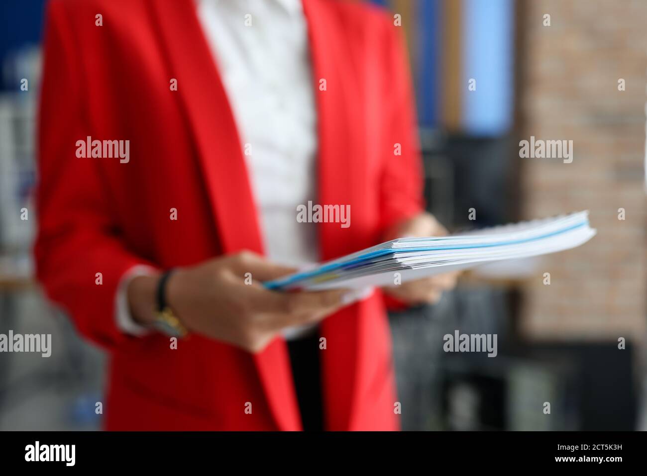 Woman in red jacket holds documents in her hands closeup Stock Photo ...