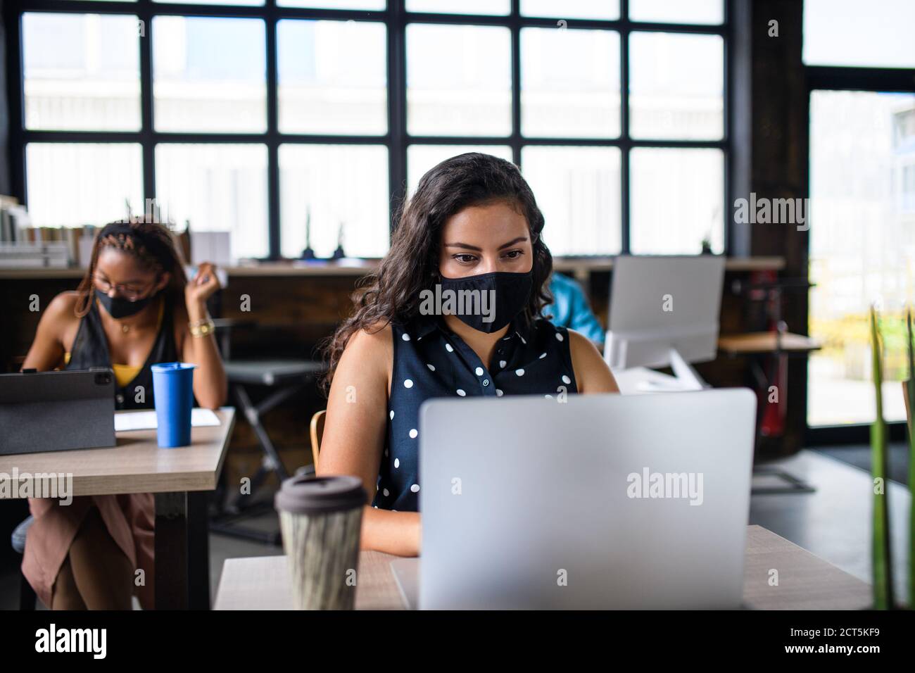 Business woman with face mask indoors in office, back to work after ...