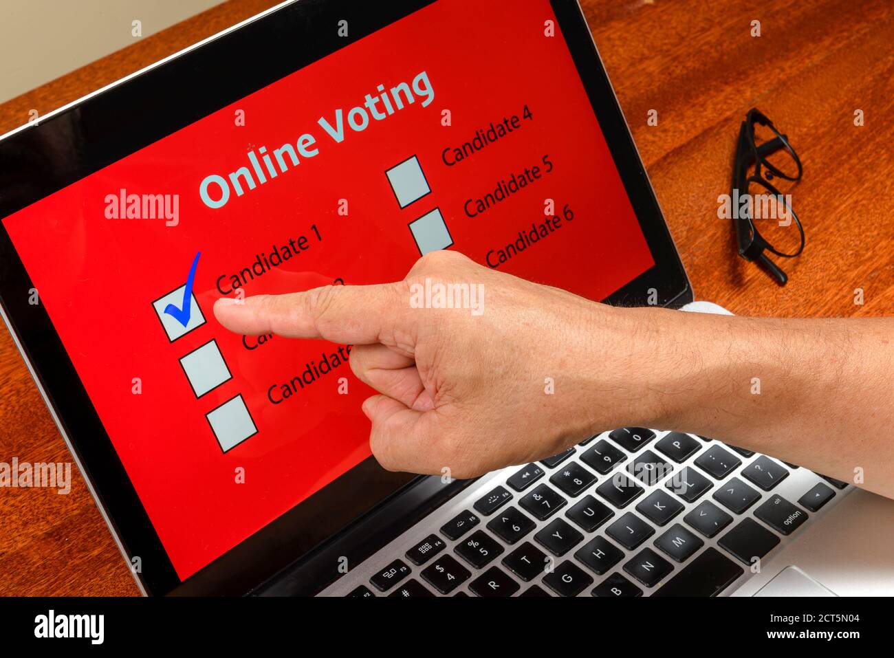 Person voting on the computer over the internet with the text online ...