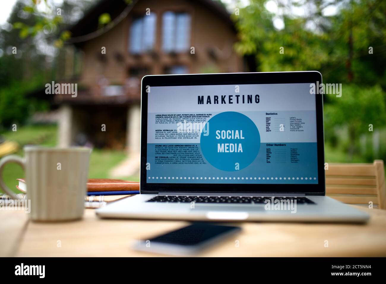 Laptop on desk outdoors in garden, home office concept Stock Photo - Alamy