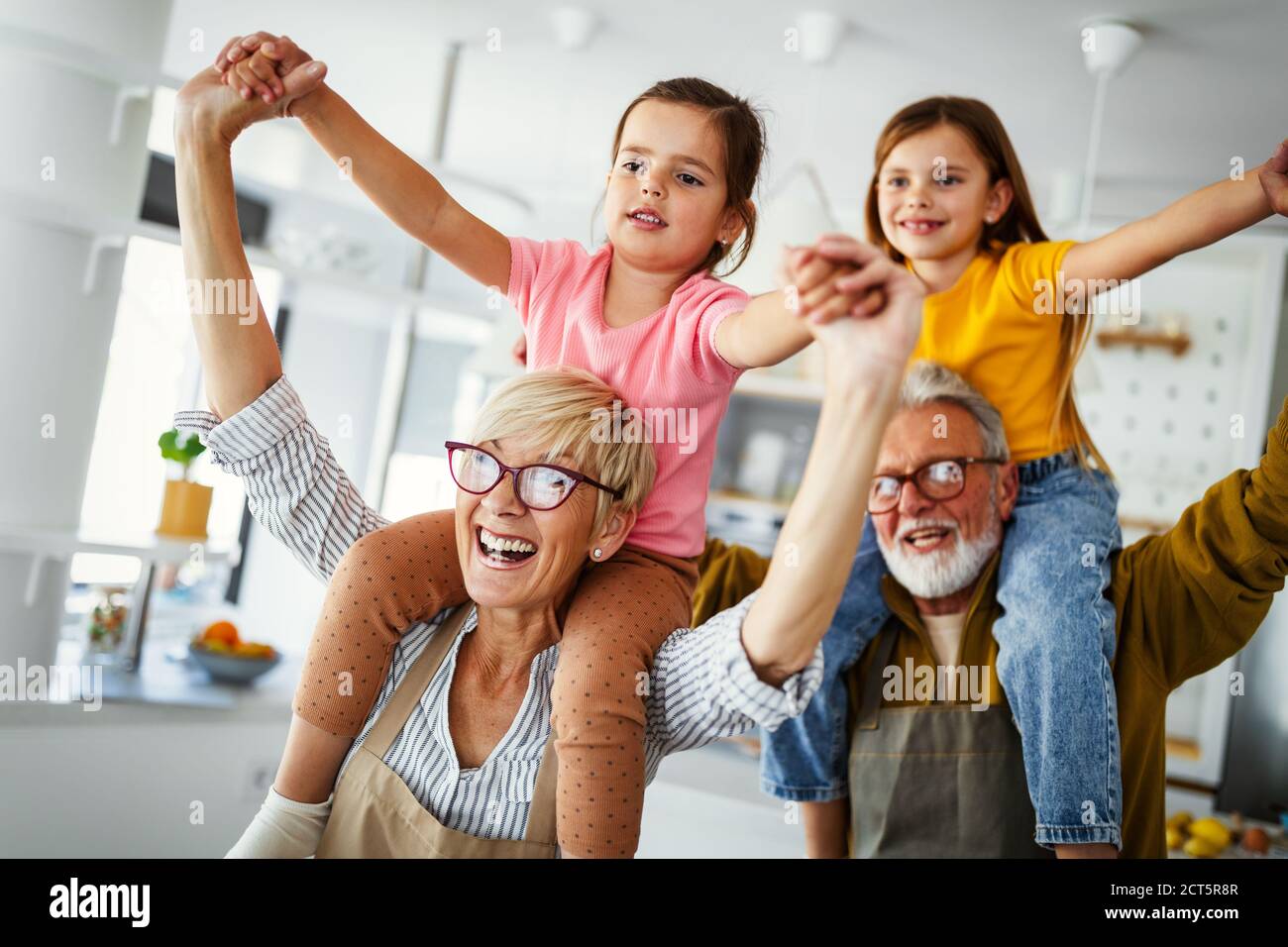 Grandchildren having fun, playing with grandparents at home Stock Photo ...