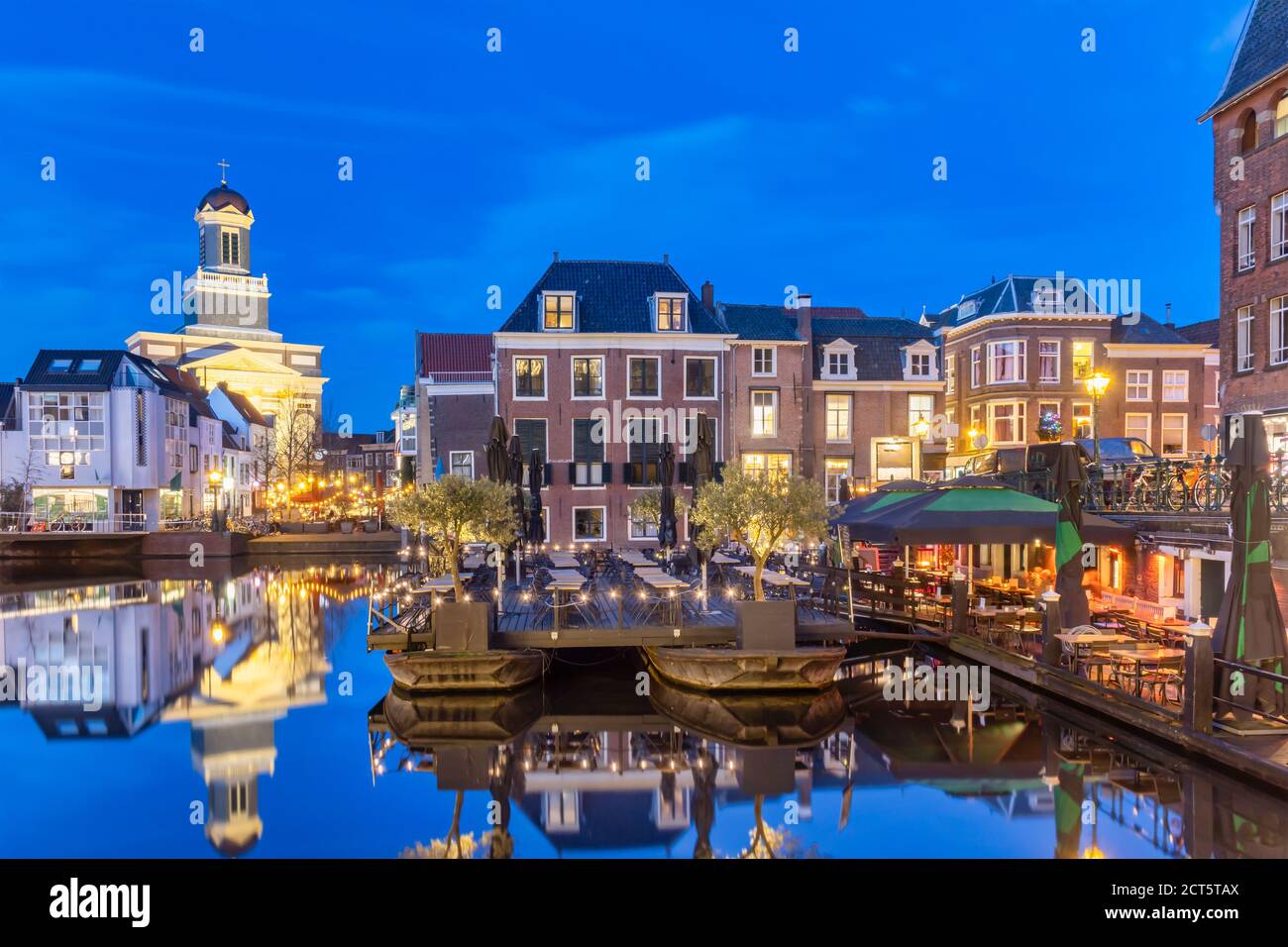 Evening view of the Dutch historic city center with water, terraces ...