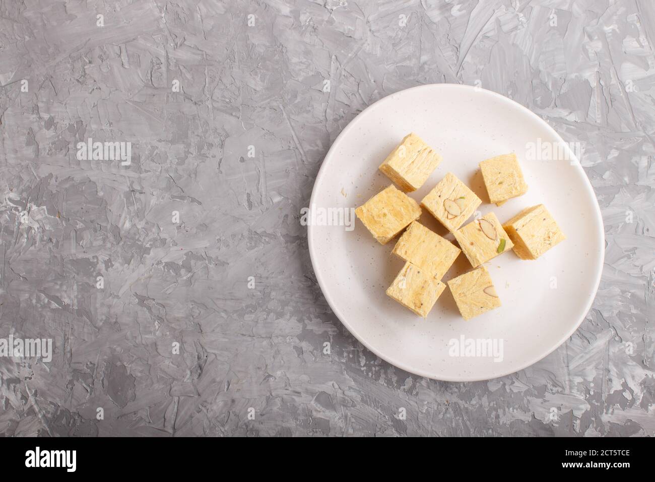 traditional indian candy soan papdi in white plate with almond and ...