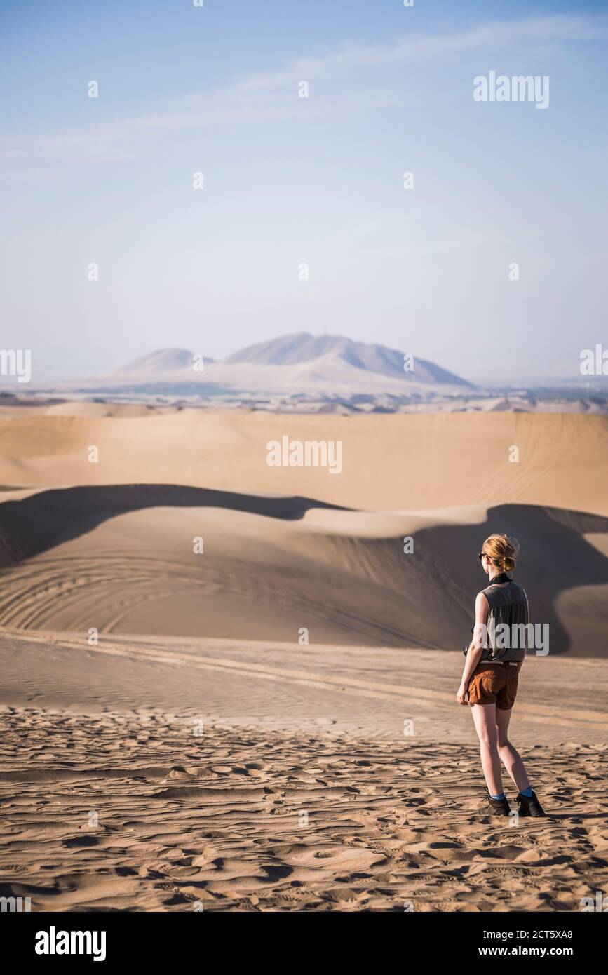 Tourist exploring sand dunes in the desert at Huacachina, Ica Region ...