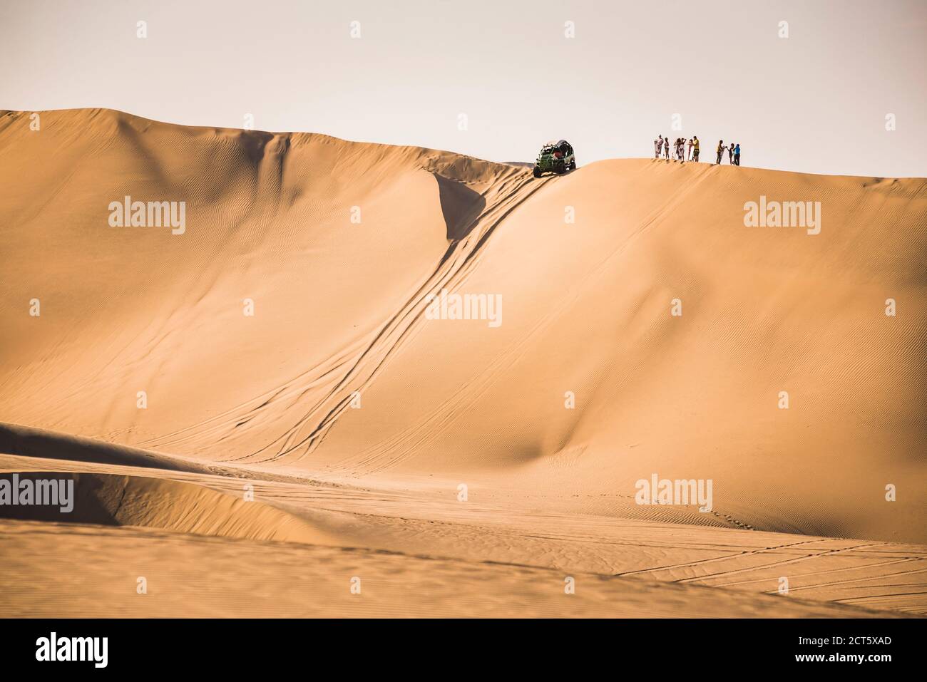 Sand boarding on dunes in the desert at Huacachina, Ica Region, Peru ...