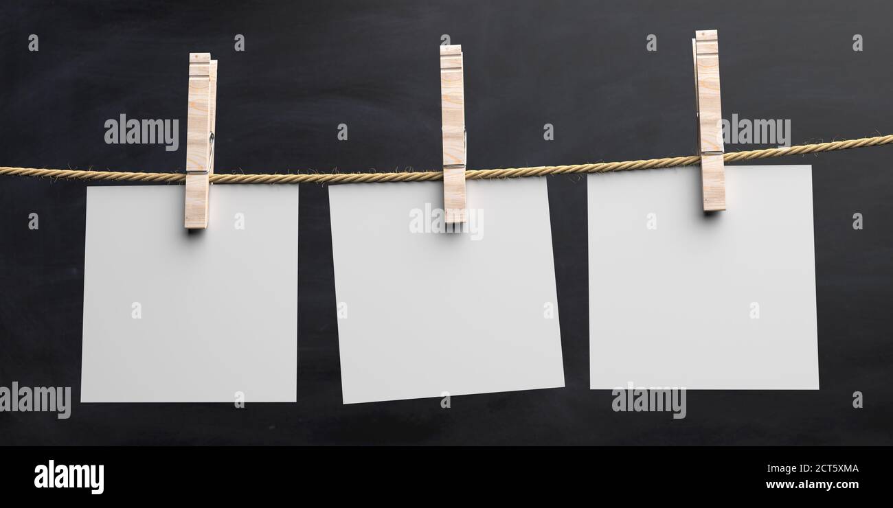 Empty paper notes holding on clothesline with wooden clothespins ...