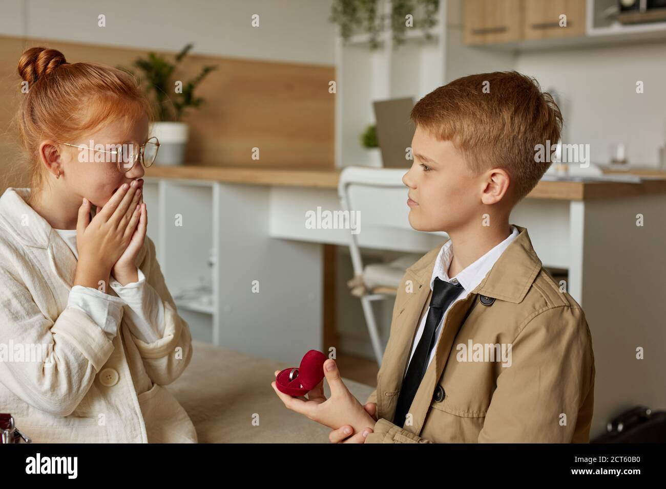 surprised little girl get proposal from her boyfriend, kid boy in coat ...