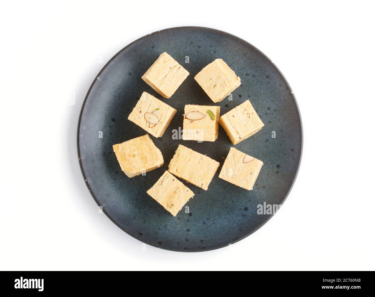traditional indian candy soan papdi in blue ceramic plate isolated on a ...