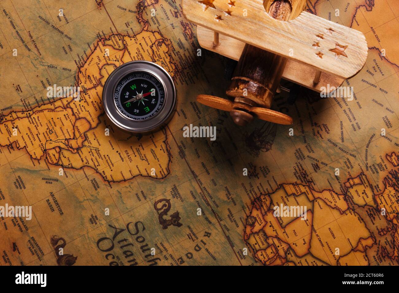 Old compass discovery and wooden plane on vintage paper antique world ...