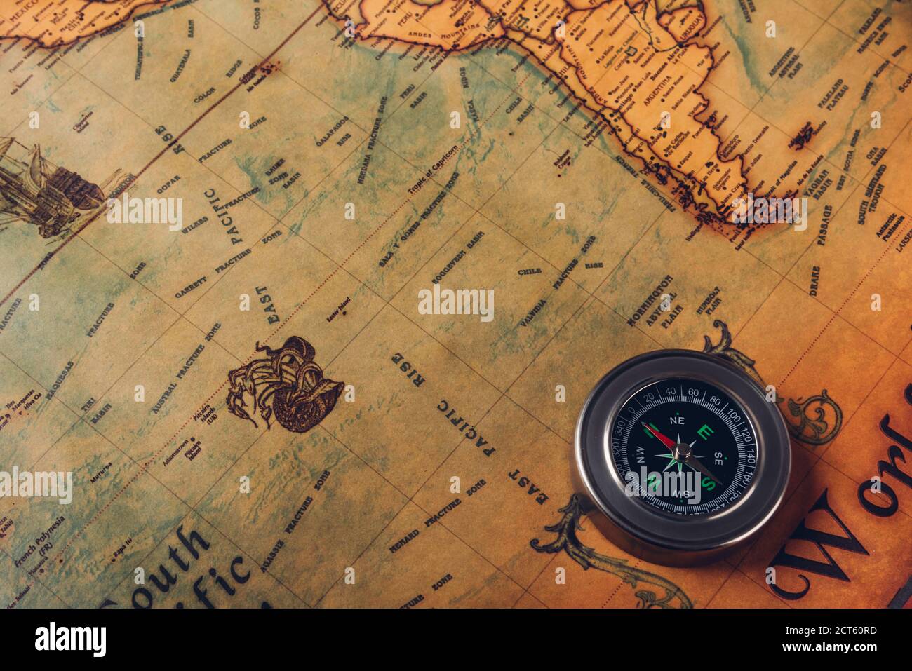 Old compass discovery on vintage paper antique world map background ...
