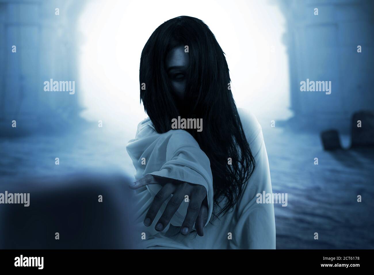 Scary ghost woman crawling with a graveyard background. Halloween ...