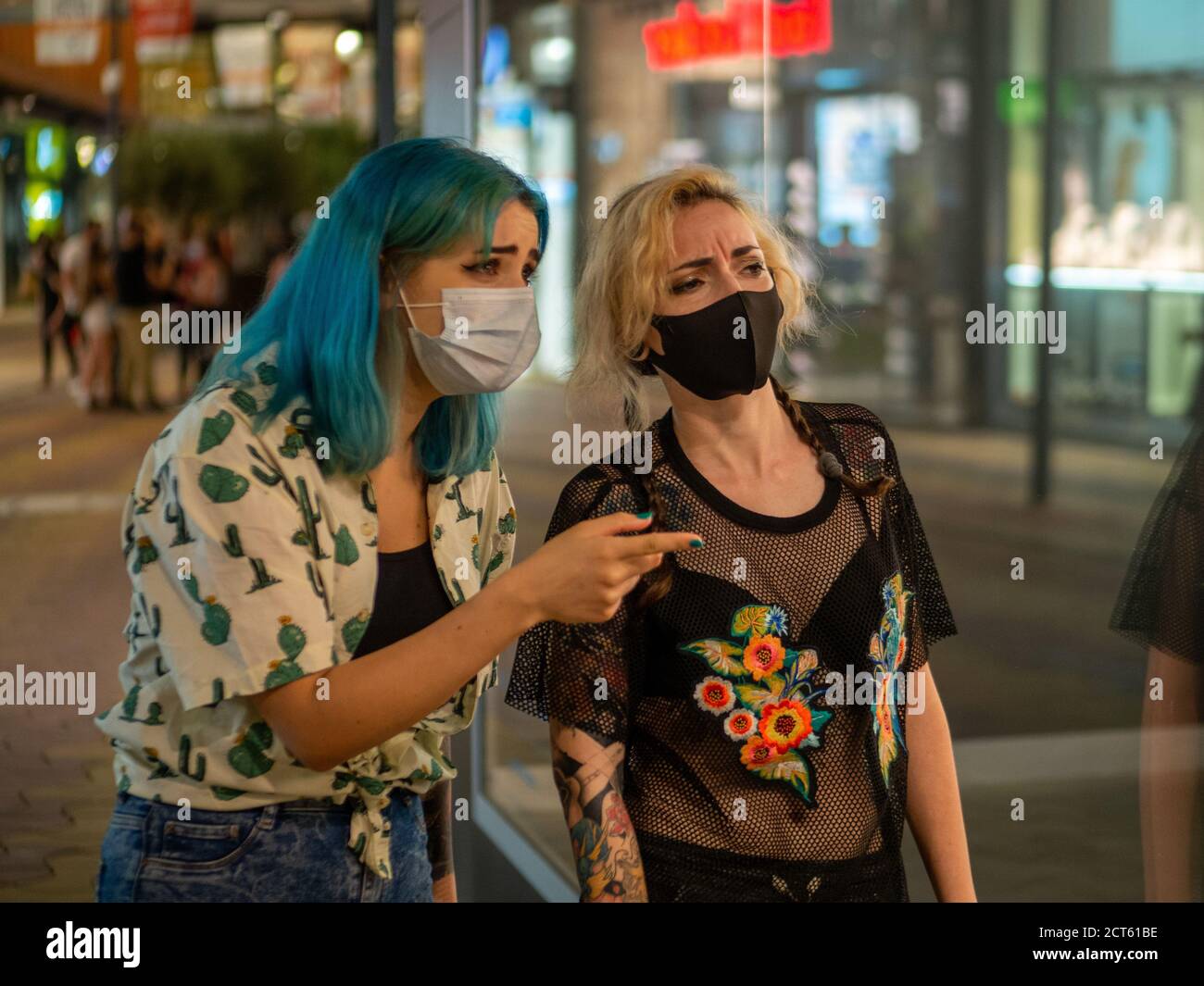 Shot of two women wearing medical masks talking to each other - new ...
