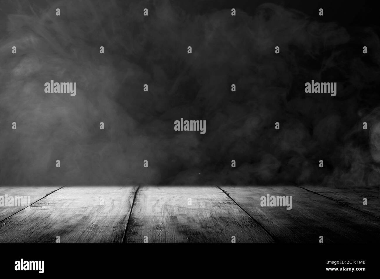 Wooden table with smoke and light on the dark room Stock Photo - Alamy