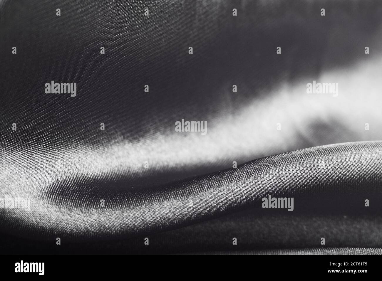 Abstract black and white textile texture with selective focus on crease ...