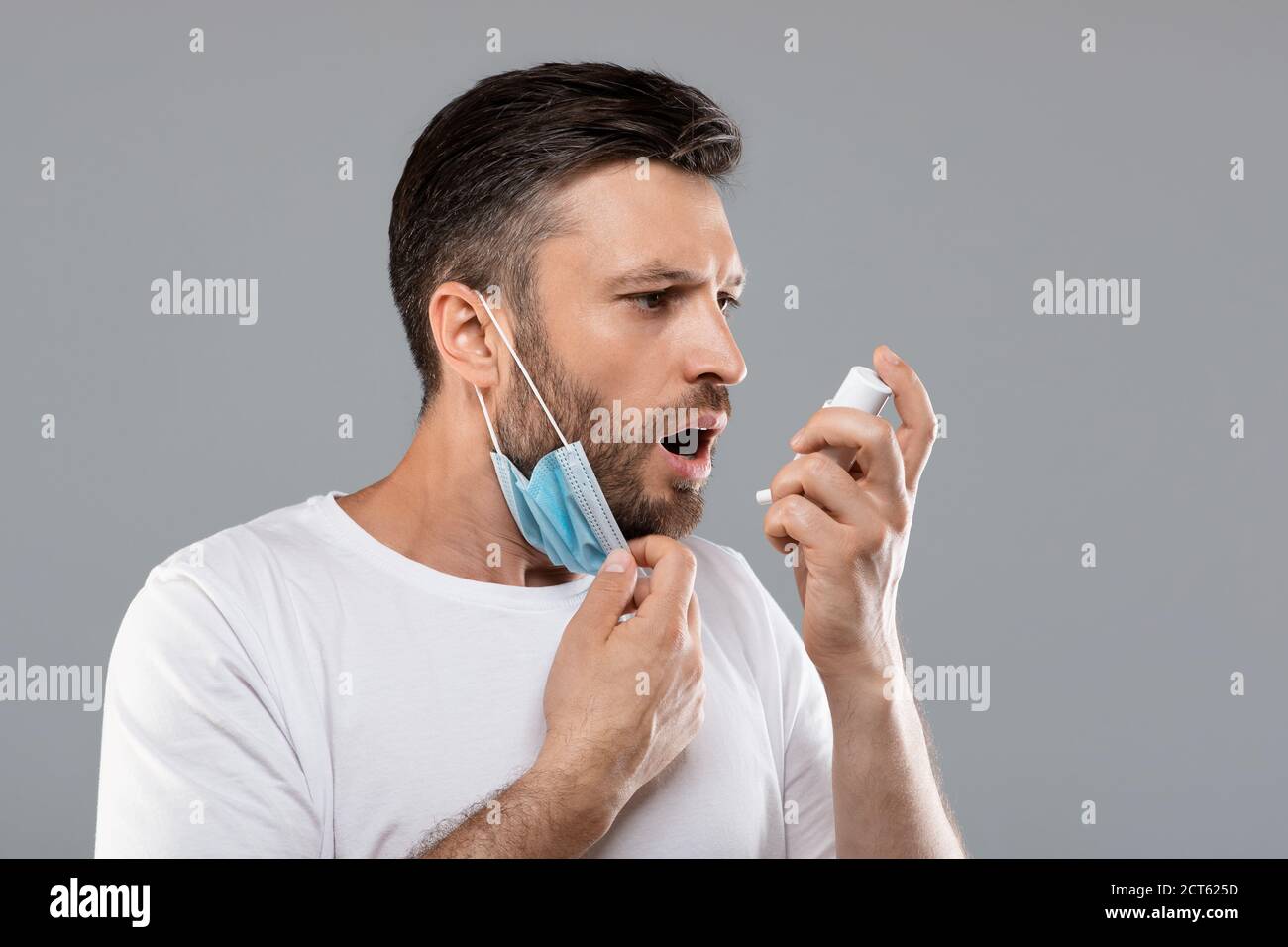 Portrait of man with protective mask using inhaler Stock Photo - Alamy