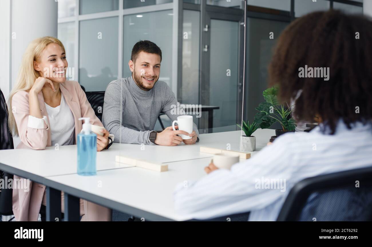 Modern office, coffee break and health protection. Multiracial ...