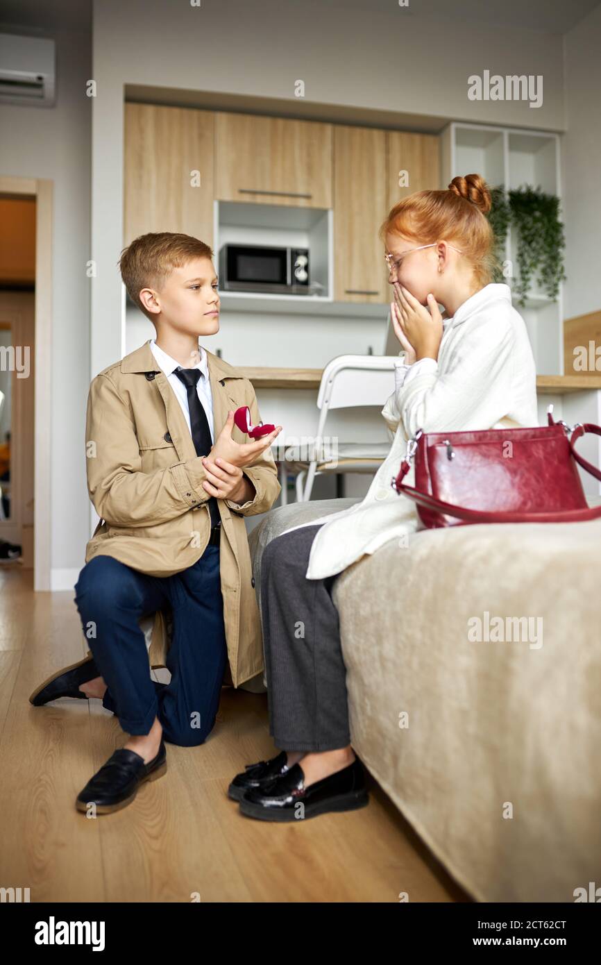 adorable kids in love, boy make proposal to redhead girl, going to be ...
