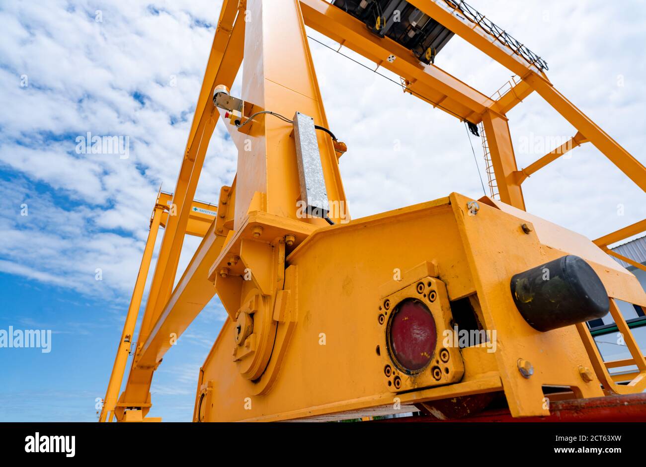 Bottom view of yellow gantry crane against blue sky at port. Gantry ...