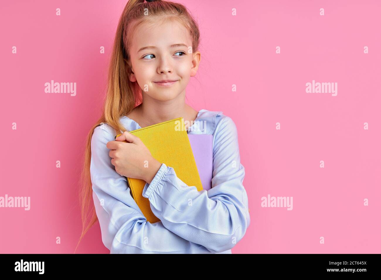 shy and diligent child girl is going to school isolated on pink ...