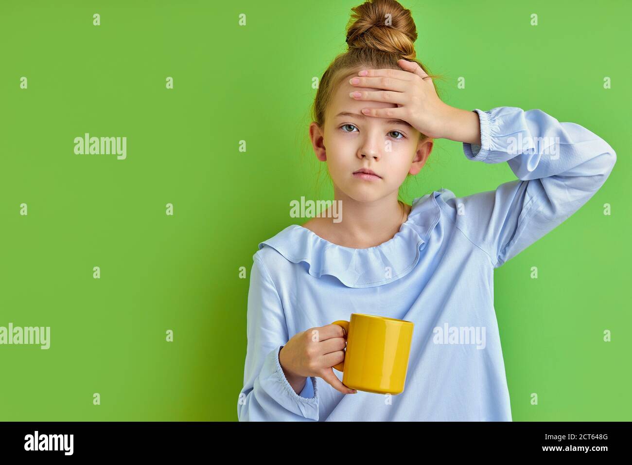 serious kid girl has headache in the morning before going to school ...