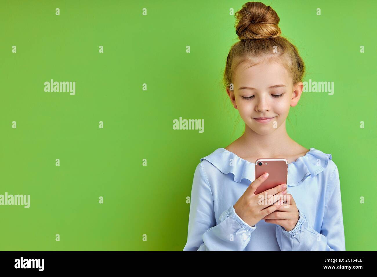 shy diligent girl spend free time wathcing video on smartphone ...