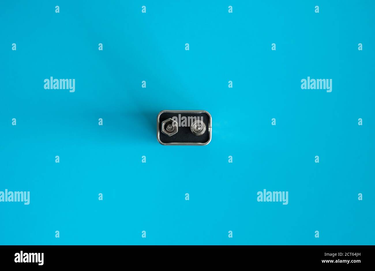 High voltage battery on a blue background. Silver Volt battery. 9V ...