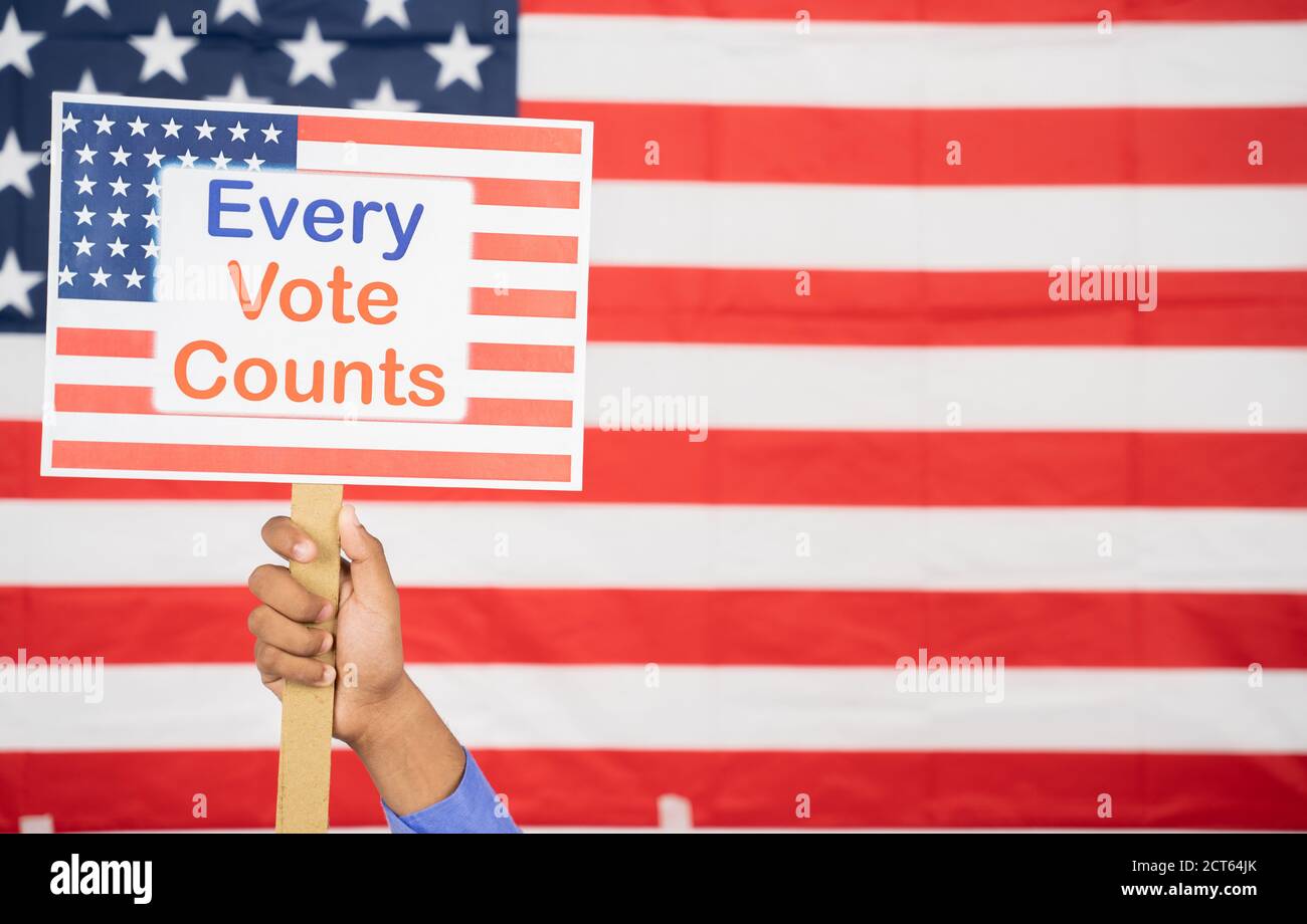 Hands Holding Every Vote counts sign board with US Flag as Background ...