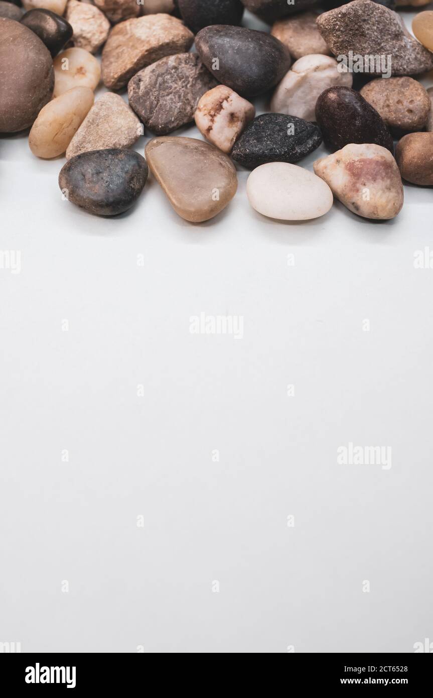 Vertical shot of rocks and pebbles on a light blue surface Stock Photo ...