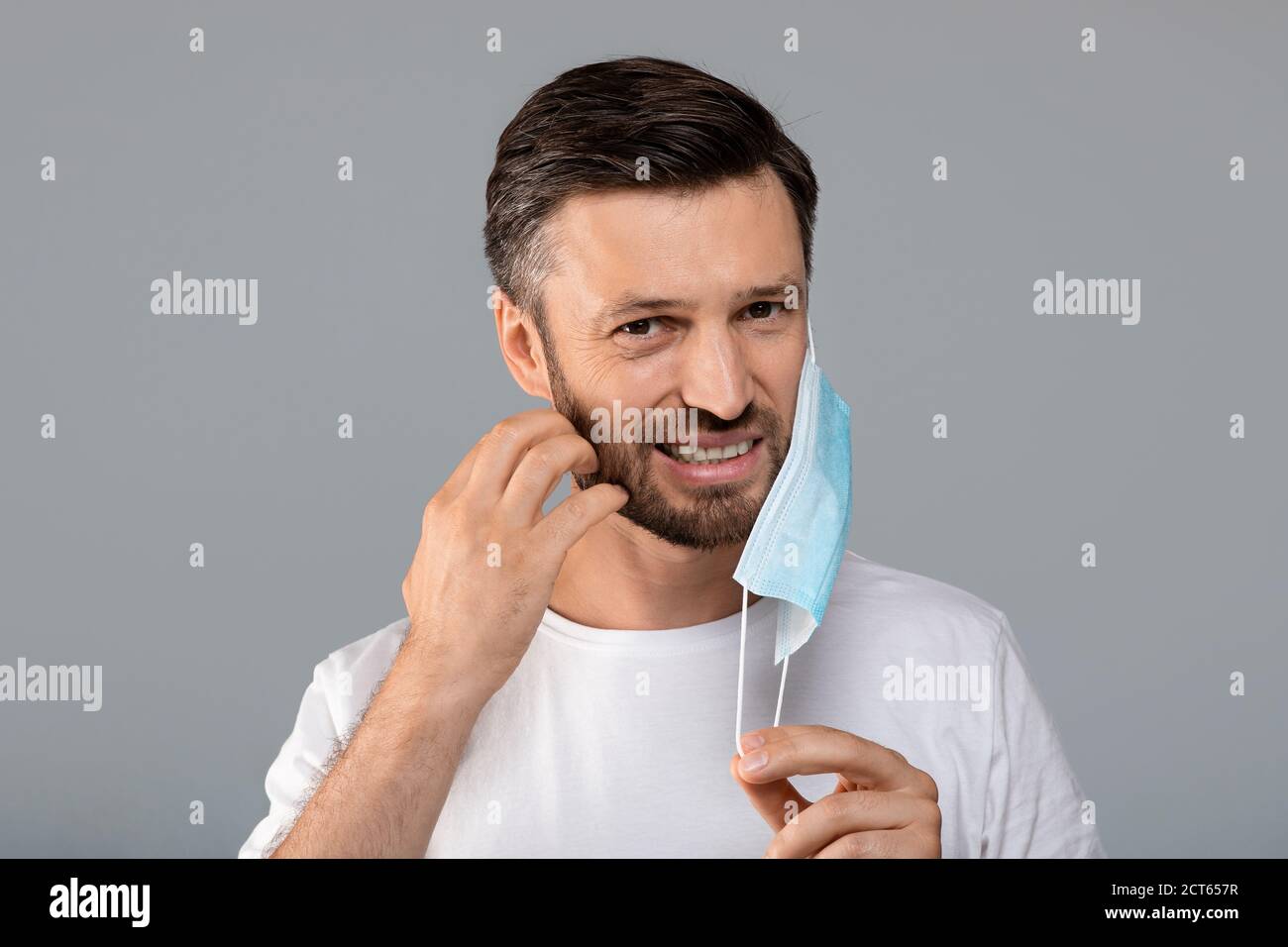 Man scratching beard mask hi-res stock photography and images - Alamy