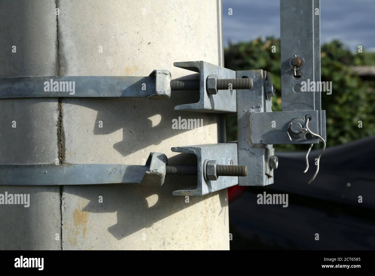 Clamps with fixing bolts on an electric pylon Stock Photo - Alamy