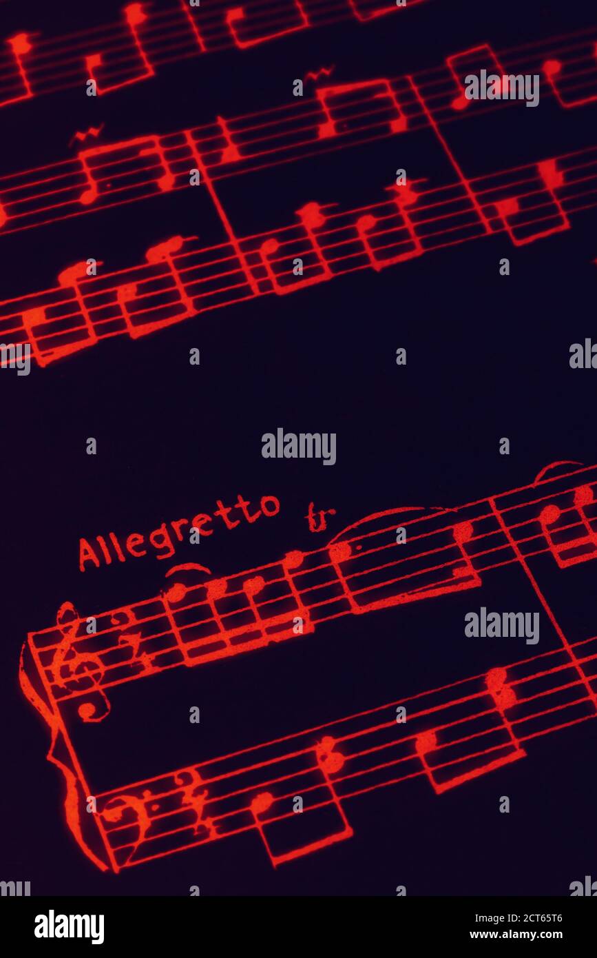 Closeup of stylized red music notes sheet with selective focus on ...