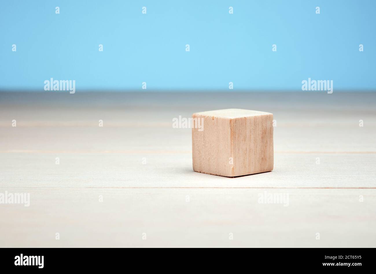 Blank empty wooden block or cube on blue background with copy space ...