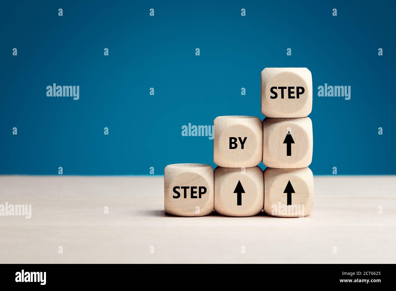 The word step by step on wooden cubes. Achievement or progress in ...