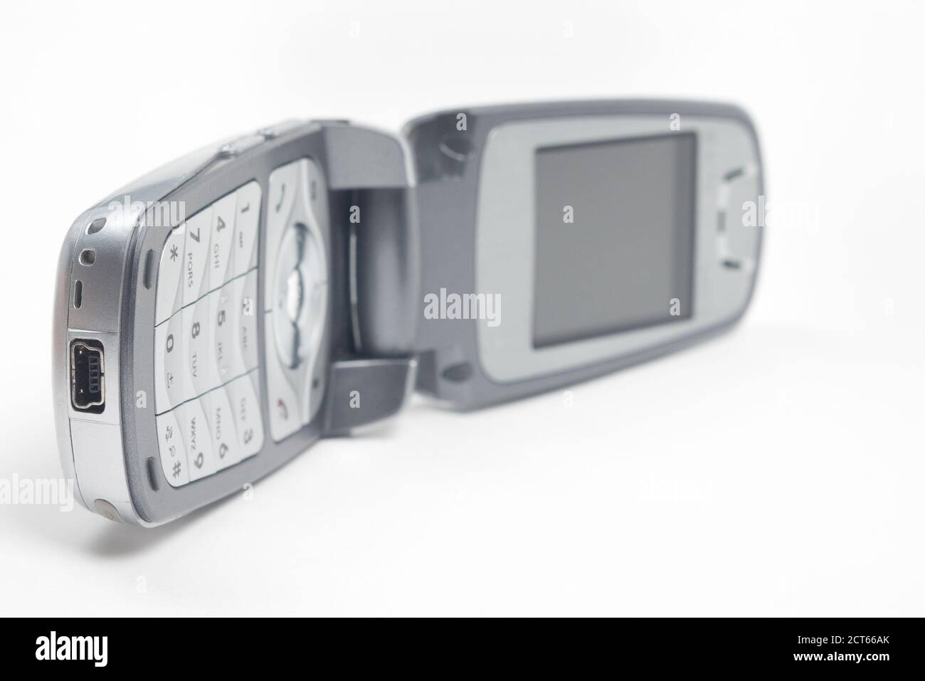 Used silver cellular mobile telephone on side with focus on mini USB ...