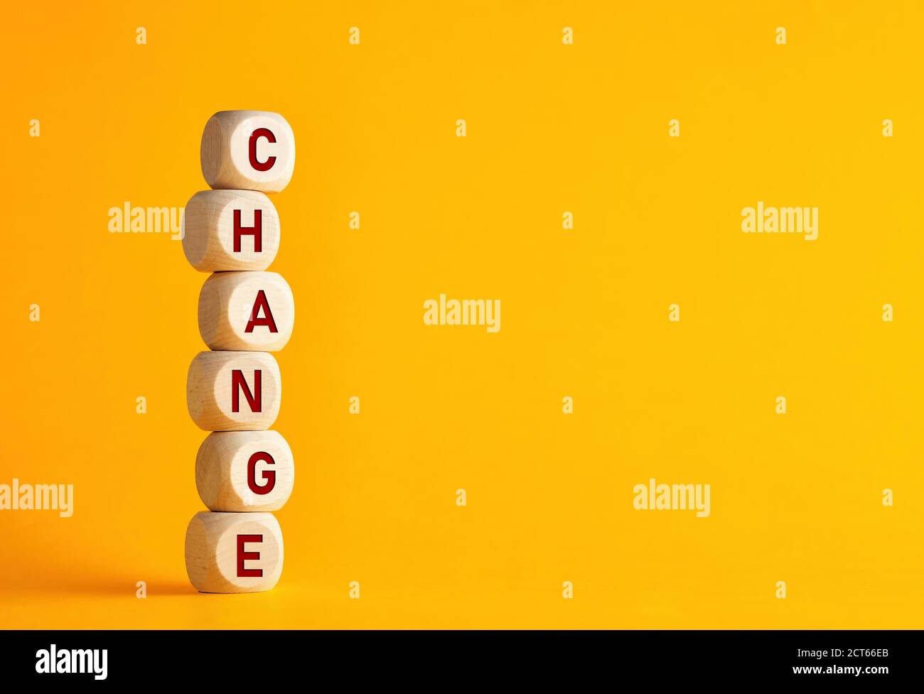 The word change on wooden cubes against yellow background. Change ...